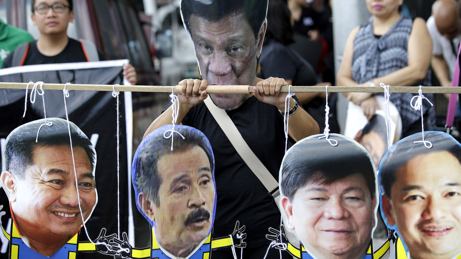 A protester wearing a mask of the Philippine President Rodrigo Duterte ...