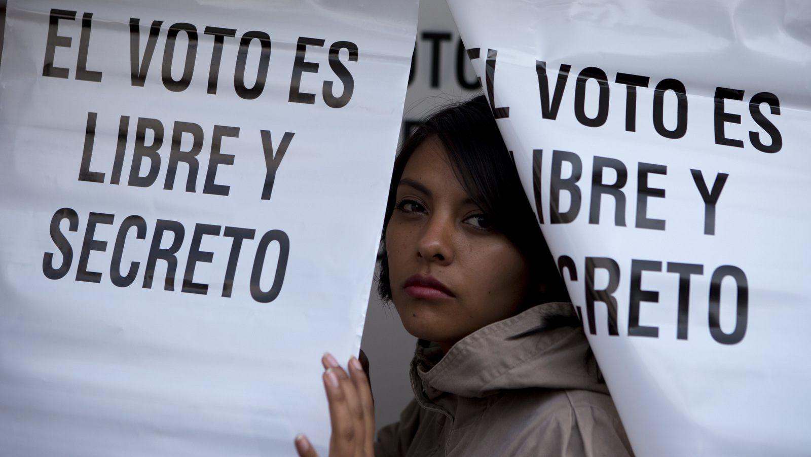 A woman emerges from a voting booth in Chimalhuacan, Mexico