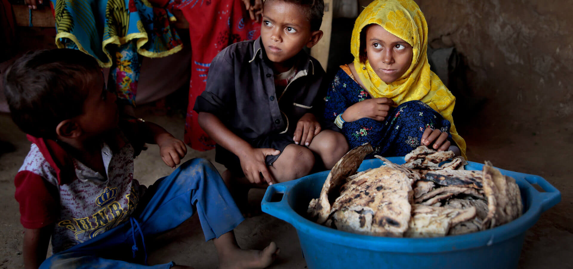 In Yemen, a mother collects moldy bread to feed her famine stricken family