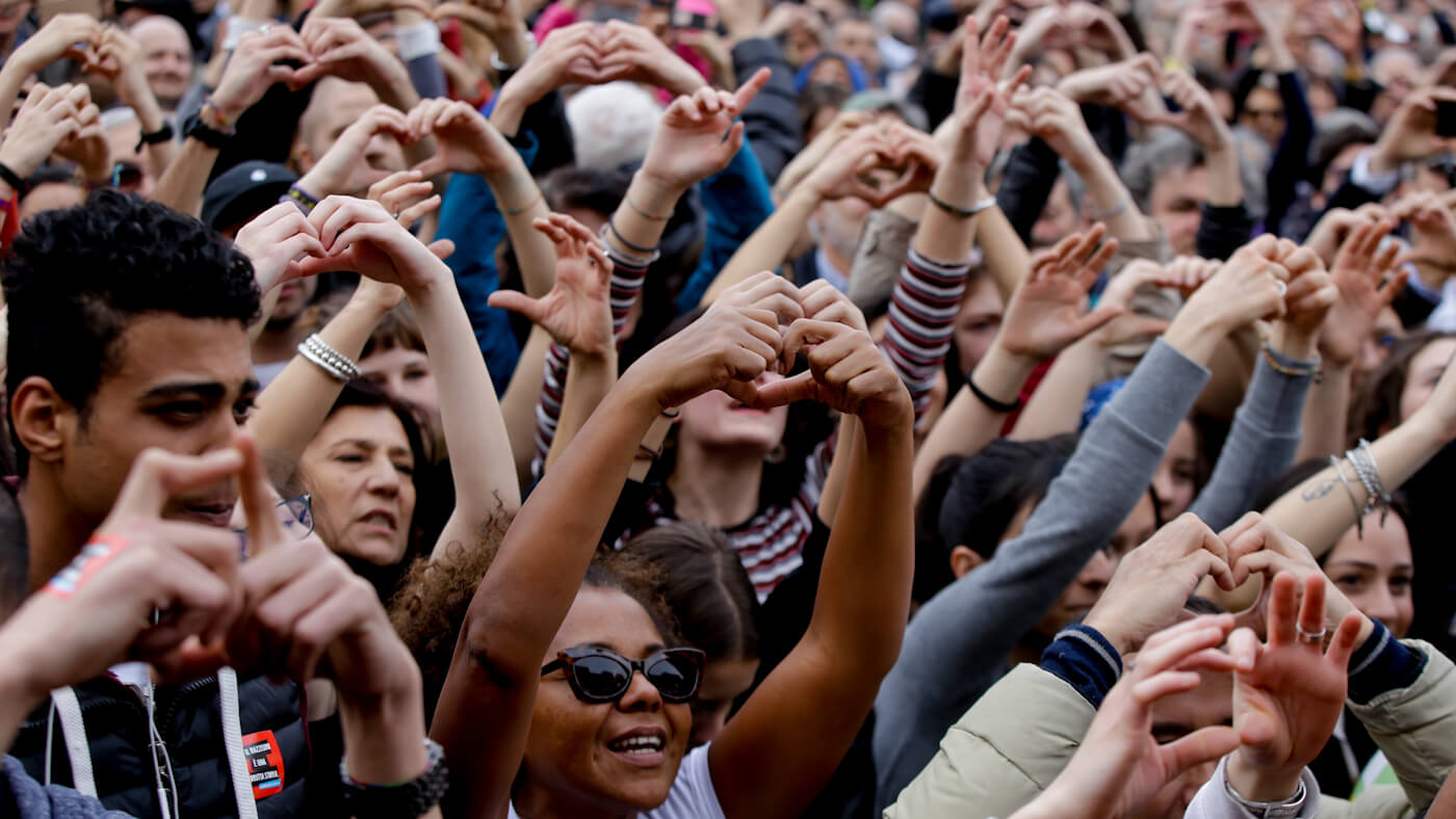 heart shaped hands anti-racism demonstration in Milan Italy